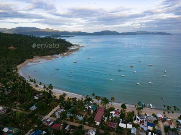 an aerial view of a beach resort in the distance and water surrounding ...