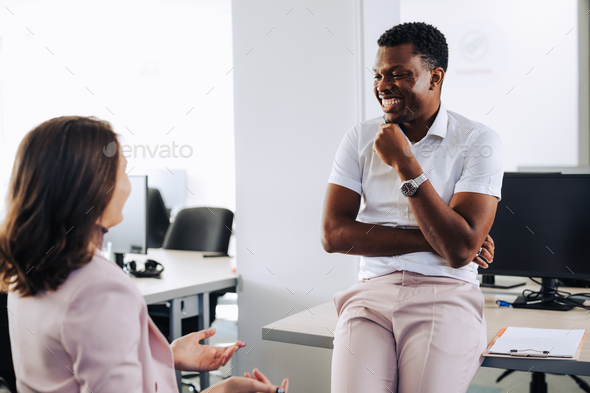 Diverse multicultural inclusive businesspeople talking at workspace ...