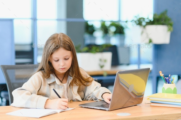 First day at school. Cute and happy little girl children using laptop ...