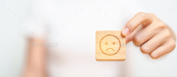 Hand choosing unhappy angry face from Emotion block. Stock Photo by ...