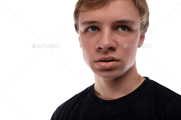 Close-up portrait of a blond 16 year old teenage boy against a ...
