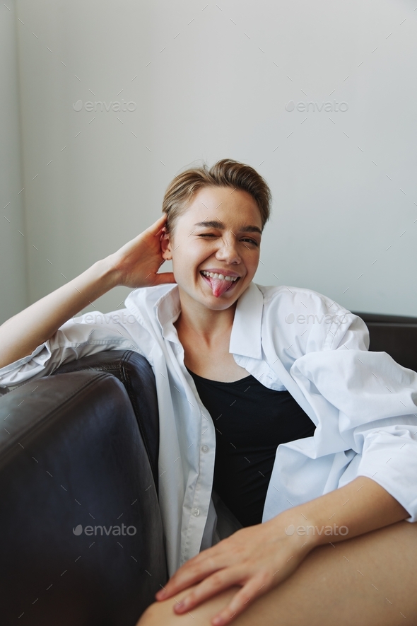 Women lying at home on the couch portrait with a short haircut in a ...