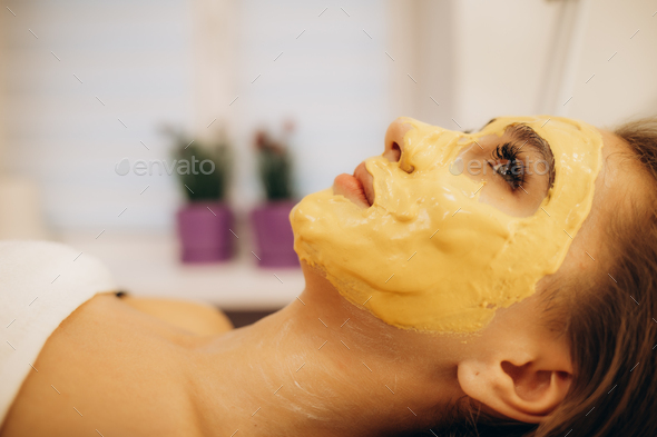 Procedure for skin care. Doctor in cosmetology office applies an yellow ...
