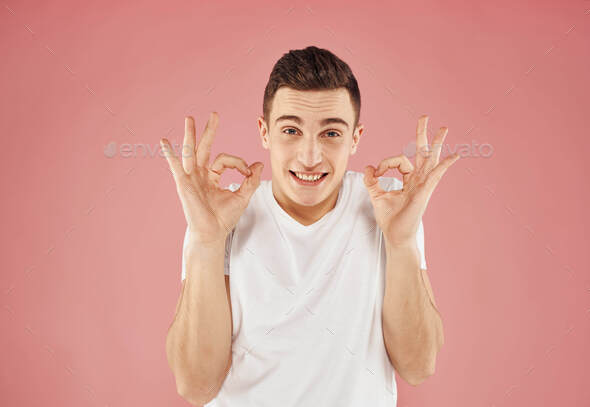 happy guy gesturing with his hands and showing fingers to the side ...