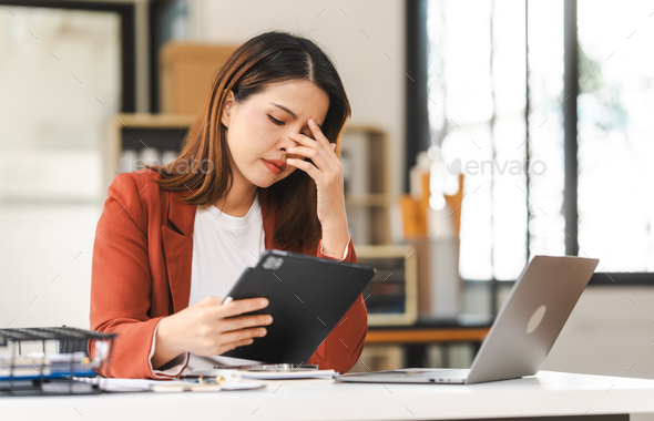 Unhappy Asian insurance agent in a formal suit feels stressed while ...