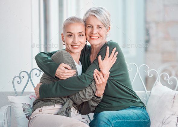 Cheerful senior mother hugging adult daughter. Loving caucasian mom giving her daughter a hug ...