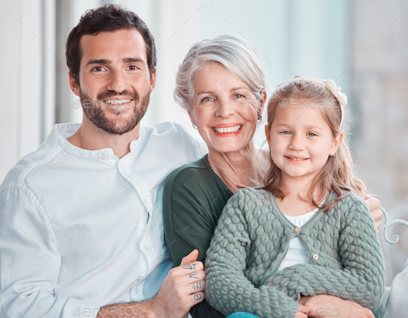 Portrait of three family members looking and smiling at the camera ...