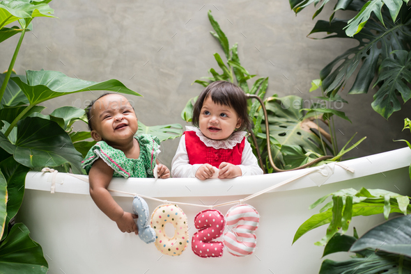 Happy diversity baby girls standing and playing in the bathtub Stock ...