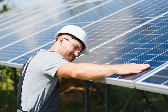 Solar panel. Technician installing solar panels on a sunny day Stock Photo by sedrik2007