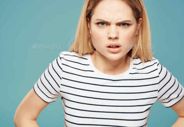 woman with displeased facial expression angry look blue background ...