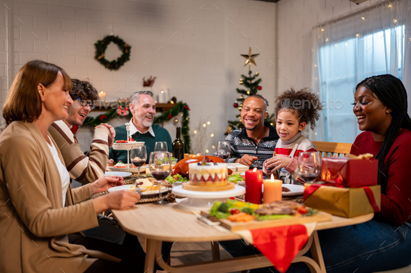 Multi-ethnic big family celebrating Christmas party together in house ...