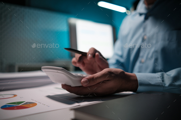 Accountant calculating numbers on calculator, Auditor is working on ...