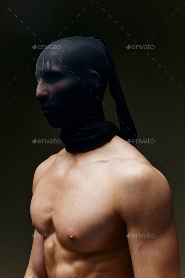 male bodybuilder in a black mask on a dark background cropped view of ...