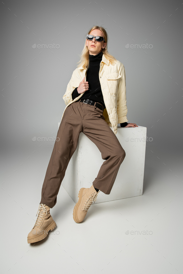 good looking non binary model in winter attire with stylish sunglasses ...