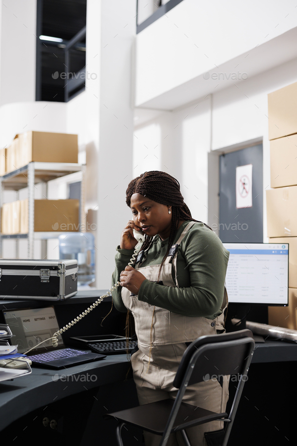Employee using landline phone to talk with remote client Stock Photo by ...