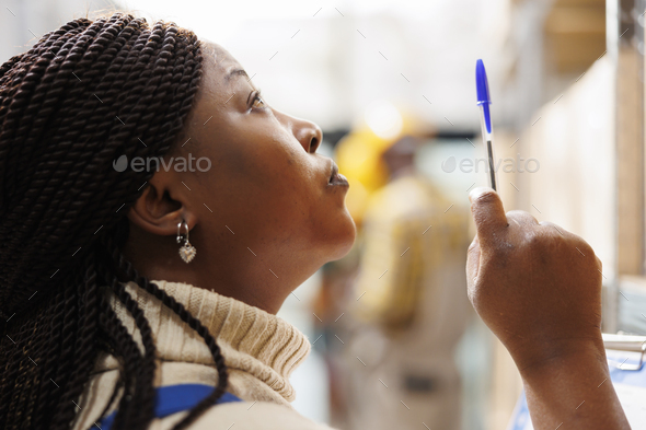Warehouse manager looking upwards and pointing with pen Stock Photo by ...