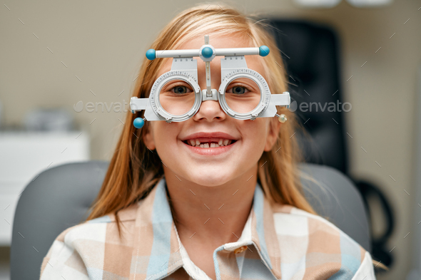 Glasses fitting and eye examination by an ophthalmologist Stock Photo ...