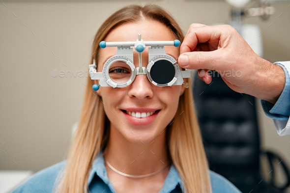 Glasses fitting and eye examination by an ophthalmologist Stock Photo ...