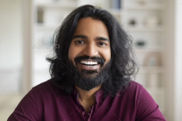 Portrait of handsome cheerful young indian man looking at camera Stock ...