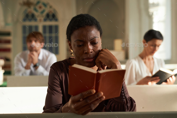 Adult African American Woman Reading Bible in Church on Sunday Stock ...