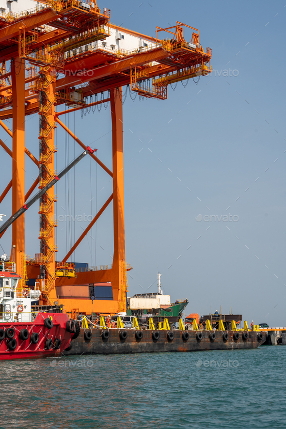 crane loading cargo container from truck to container ship in the international terminal Stock ...