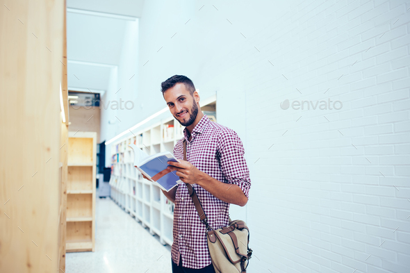 Smiling male reading magazine in bookshop Stock Photo by GaudiLab ...