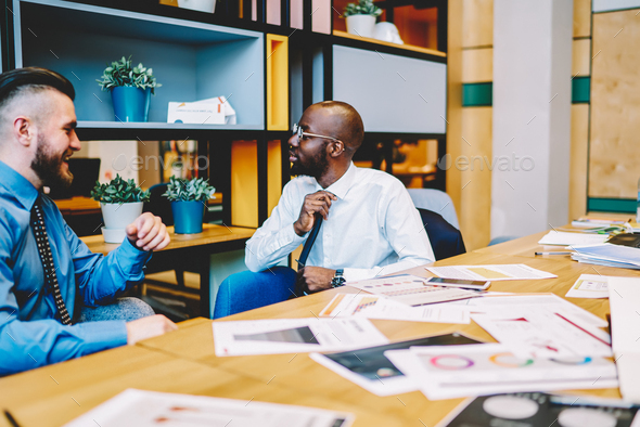 Black office employee taking break listening coworker in office Stock ...