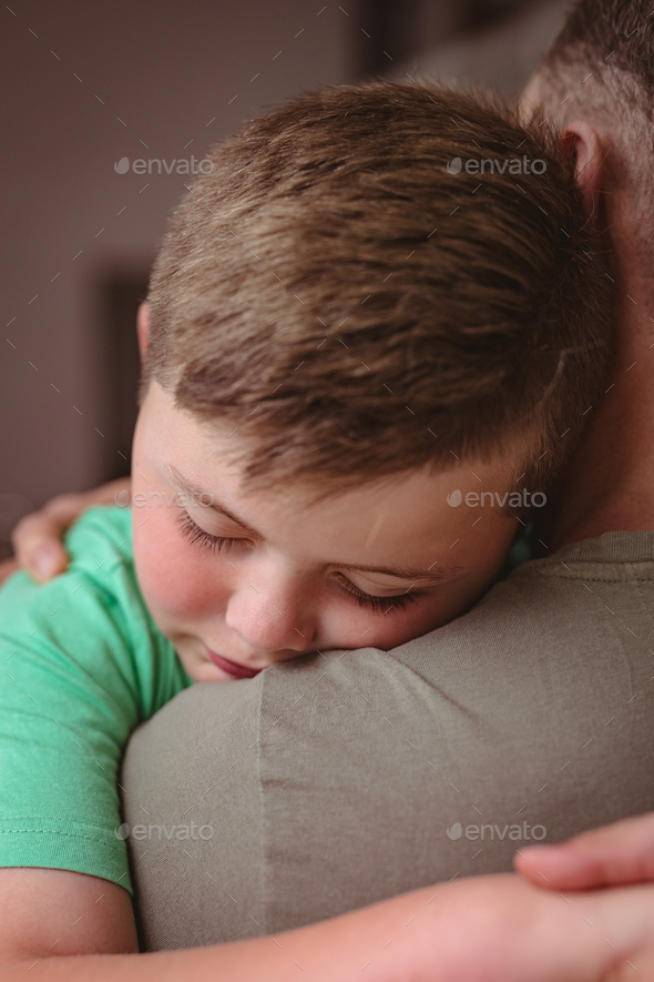 Close up view of caucasian boy hugging his father at home Stock Photo ...