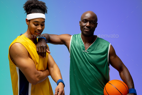 Image of portrait of two diverse basketball players with basketball on ...