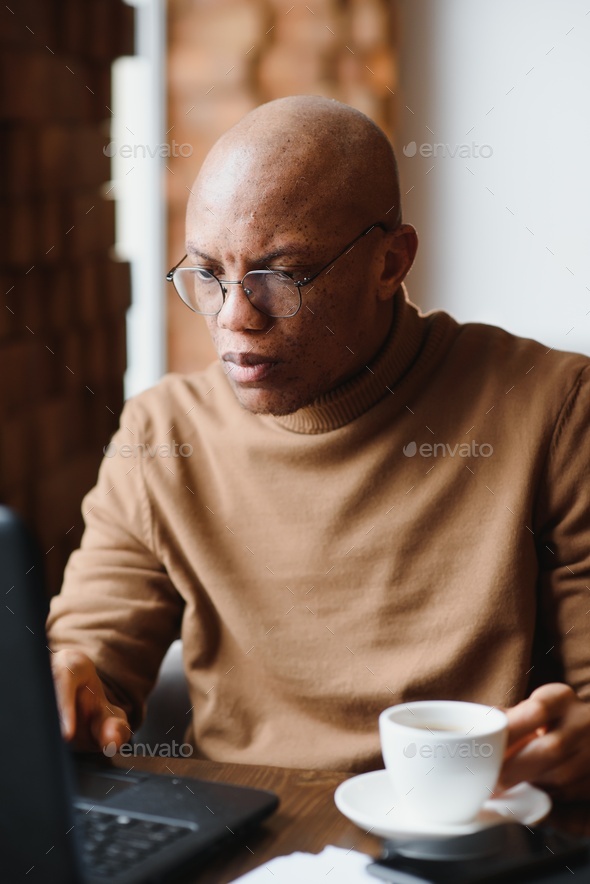 Confident prosperous African-American young top-manager Stock Photo by ...