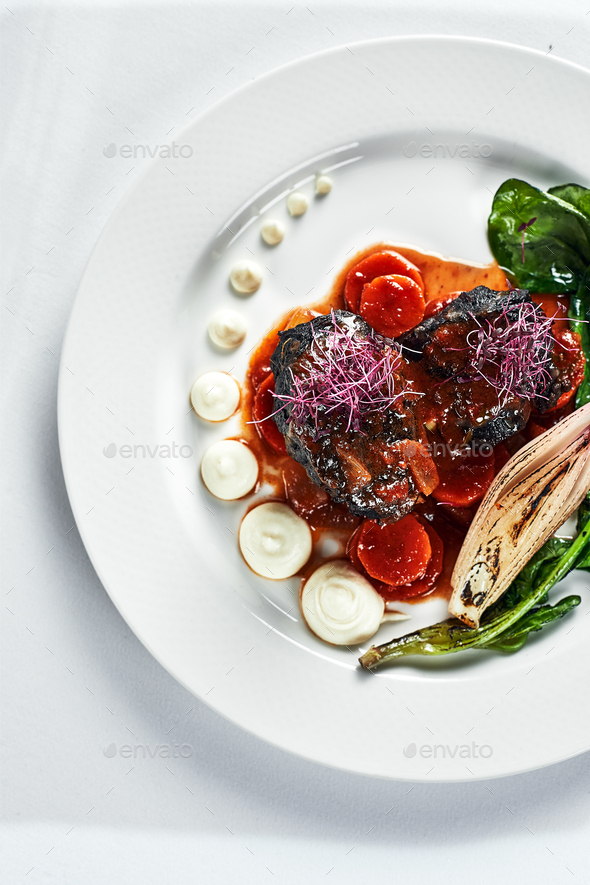 Braised beef cheeks with vegetables on a white plate Cooking beef ...