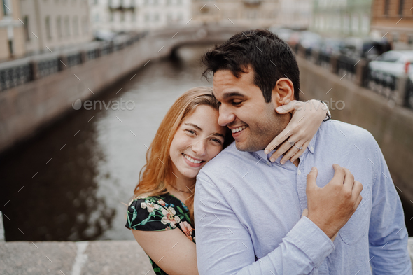 Close couple embracing by the canal, sharing a serene moment. Love ...