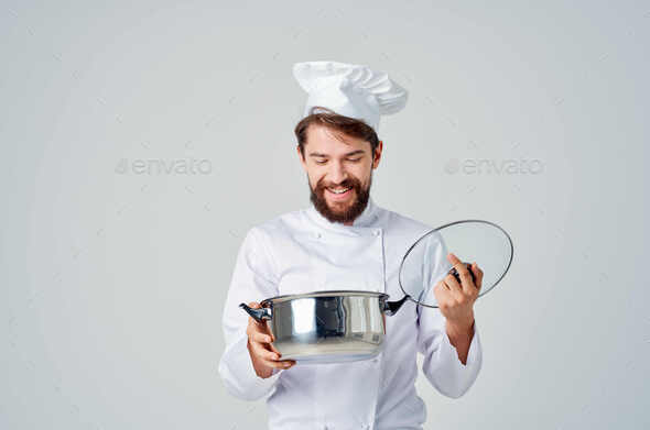 male chef with a saucepan in his hands cooking food kitchen lifestyle ...