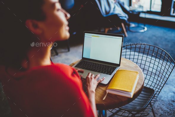 Smart female browsing laptop in workplace Stock Photo by GaudiLab ...
