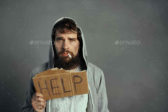 bearded homeless man holding a sign Help emotions poverty on the street ...