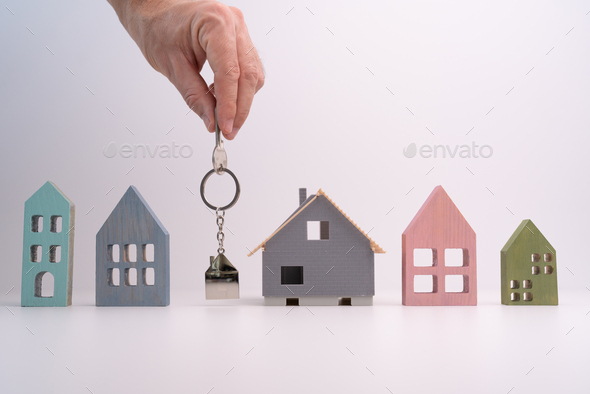 Hanging keys in hand between colorful houses left and right Stock Photo ...