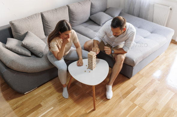 Couple playing block stacking balancing game Stock Photo by ...