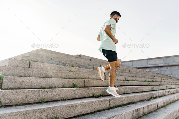 Athlete trainer exercises to warm up muscles. Hobby jogging in running ...