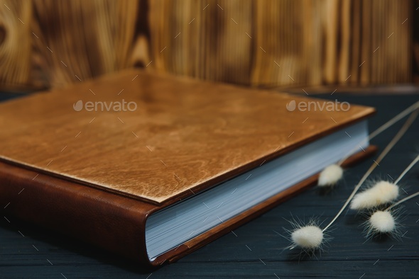 Luxury wooden photo book on natural background. Family memories ...