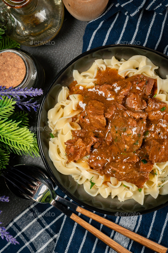 Pasta with beef stew in black bowl. Stock Photo by foto_pstryki | PhotoDune