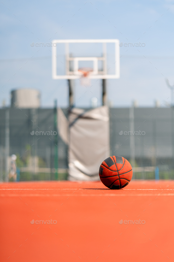 Close-up of basketball that lies on the floor of a basketball court in ...