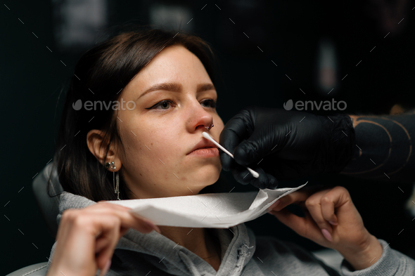 Piercing process Professional nose piercing for a girl the master ...