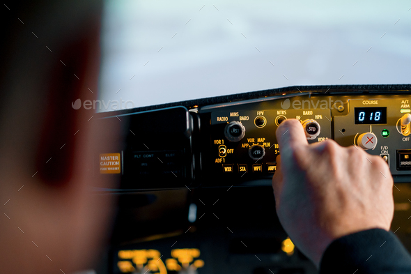 Airplane cockpit View from behind the pilot's shoulder Pressing buttons ...