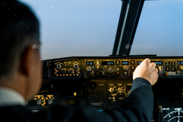 The pilot in the cockpit of the aircraft turbulence during the flight ...