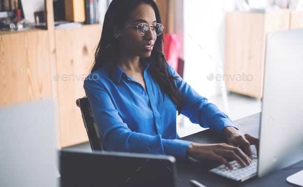 Black woman concentrated on typing on keyboard in office Stock Photo by ...