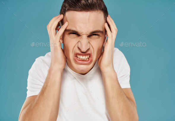 angry man with displeased facial expression in white t-shirt Stock ...