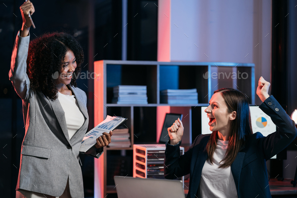 Successful business team, excited young people Keeping up arms and ...