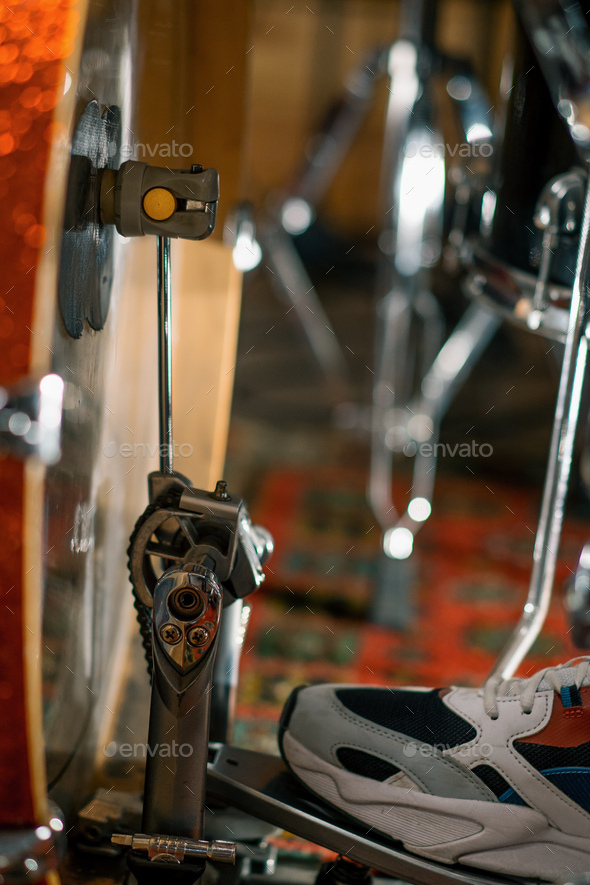 man's foot pressing bass drum pedal in recording studio drummer ...