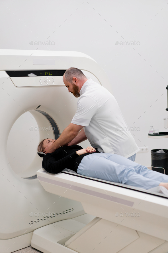 A radiologist performs a computer tomography procedure in a medical ...