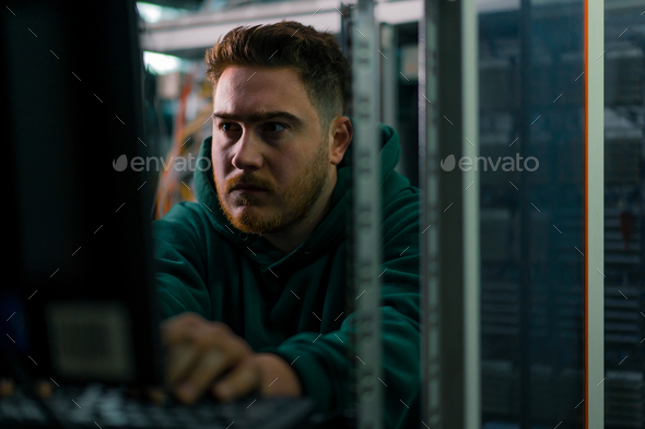 focused hacker in data center hacking software system vulnerable cyber ...